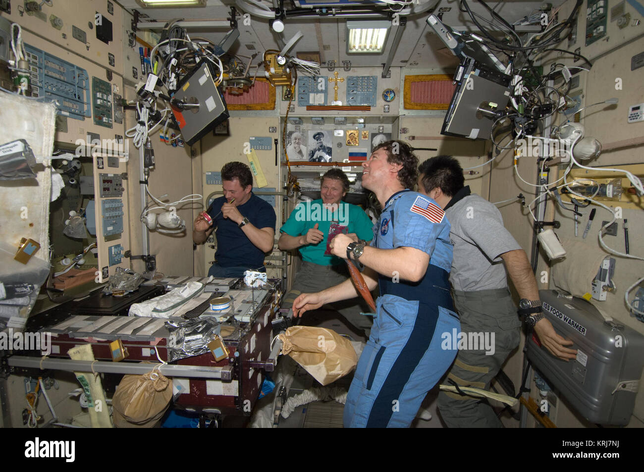 ISS-20 Crew members share a meal at the galley in the Zvezda Service ...