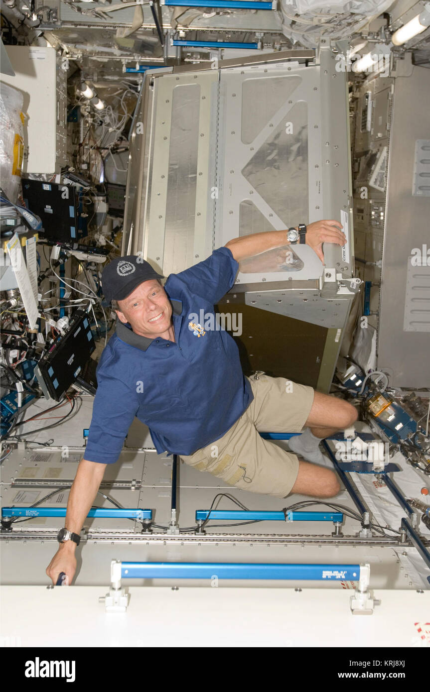 STS-128 Christer Fuglesang prepares to install a new crew quarters ...