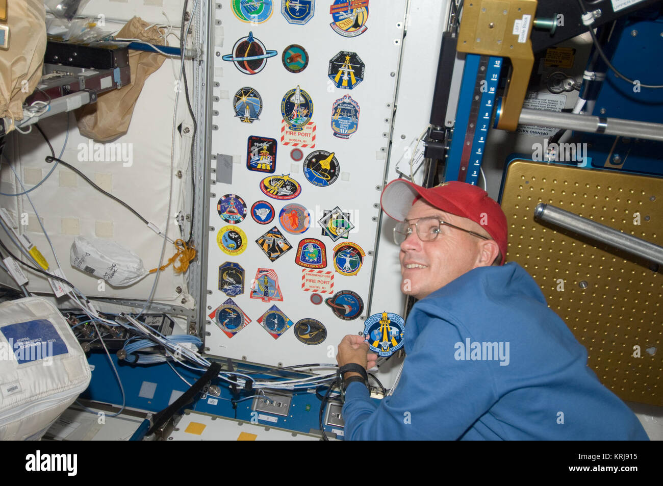 STS-128 Rick Sturckow adds his crew's patch to a wall of the Unity node Stock Photo - Alamy