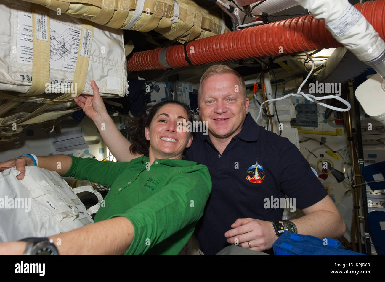 STS-133 Nicole Stott and Eric Boe on Discovery's middeck Stock Photo ...