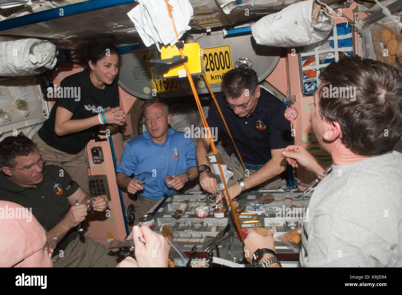 STS-133 ISS-26 crew members share a meal in the Unity node Stock Photo ...