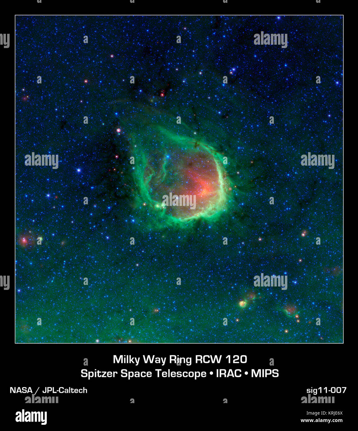 This glowing emerald nebula seen by NASA's Spitzer Space Telescope is ...