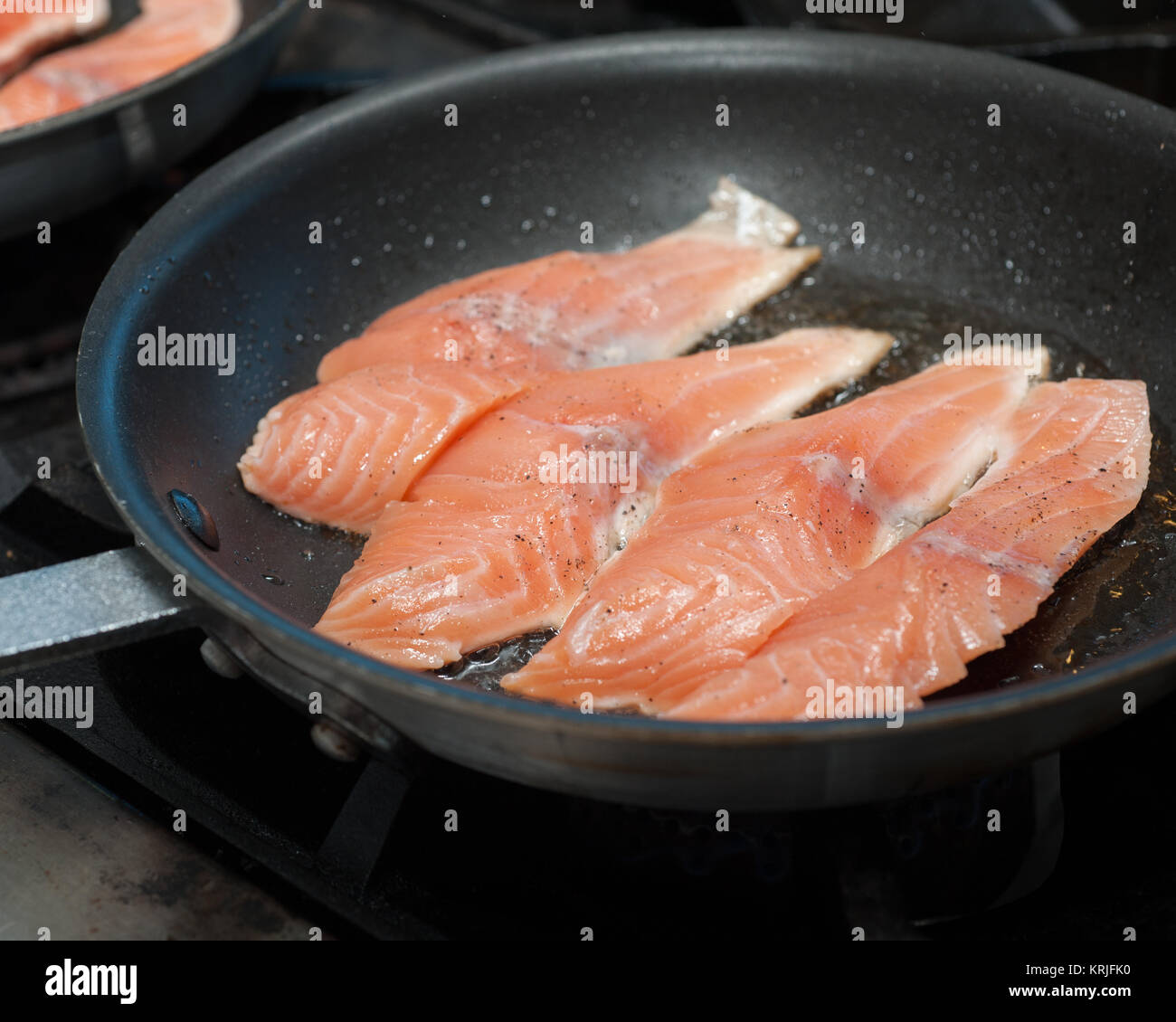 Fish in a frying pan Stock Photo - Alamy