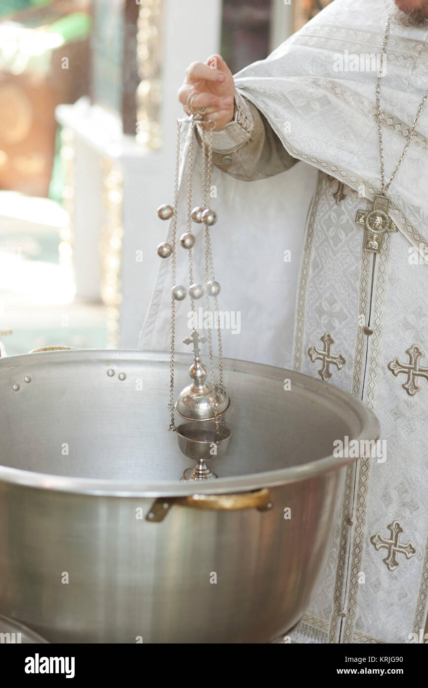 Priest holding chalice in bowl Stock Photo - Alamy