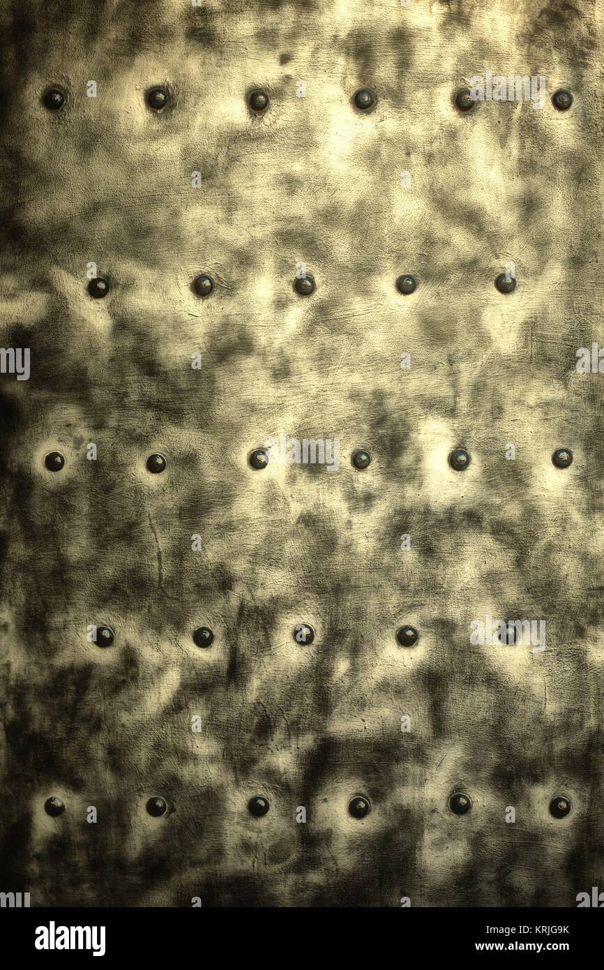 Closeup of grunge gray grey metal plate with rivets and screws as ...
