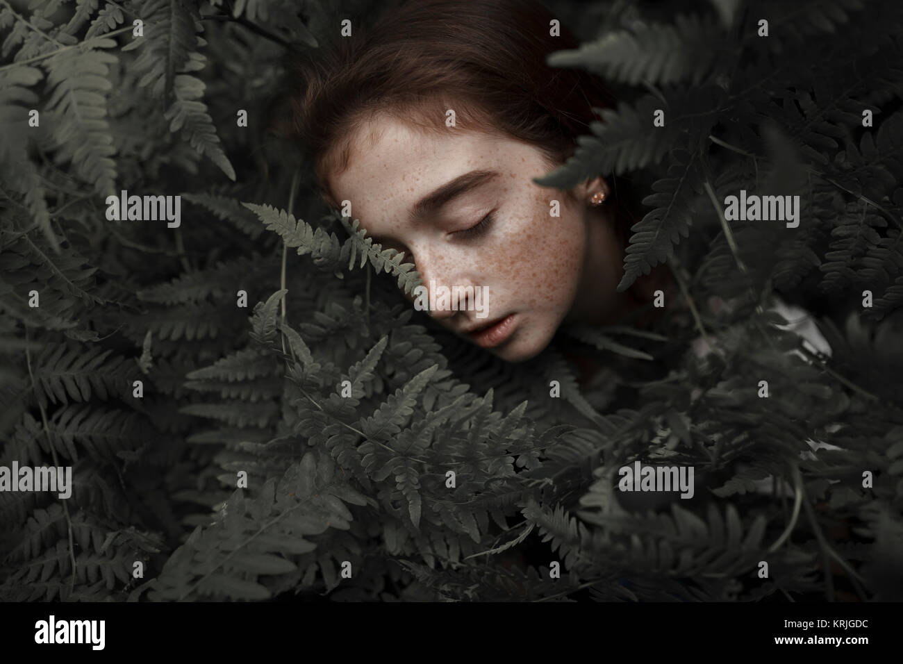 Caucasian girl with freckles resting in leaves Stock Photo - Alamy