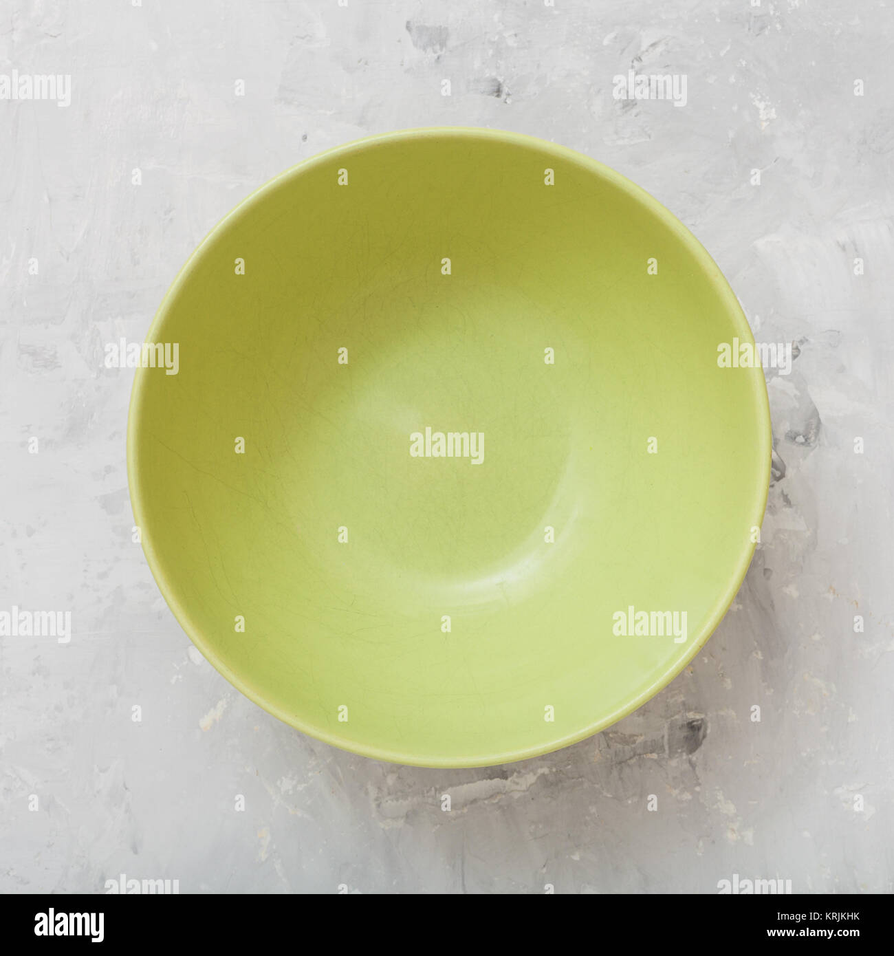 above view of green bowl on concrete plate Stock Photo - Alamy