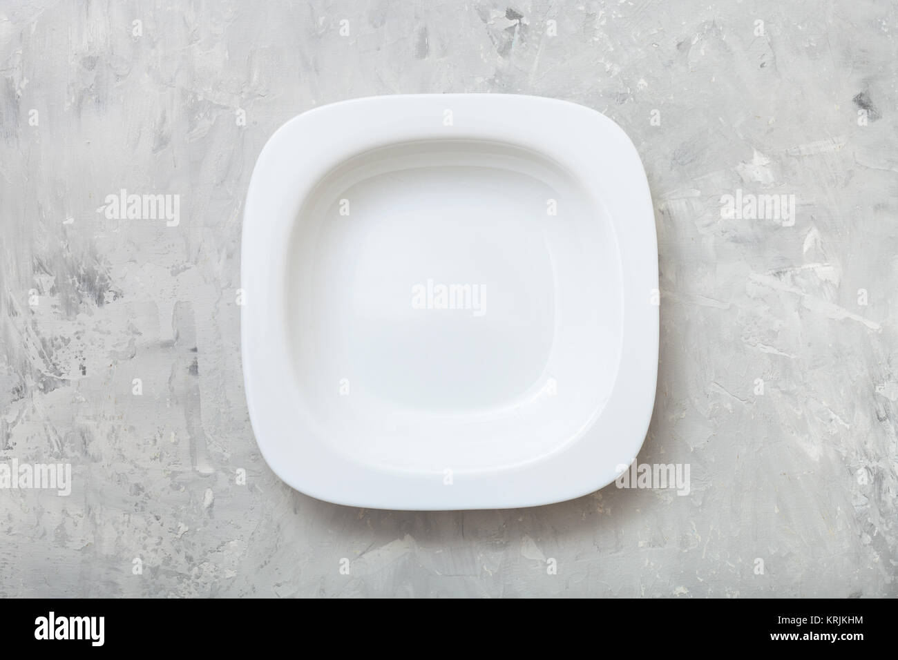 above view square white deep plate on concrete Stock Photo - Alamy