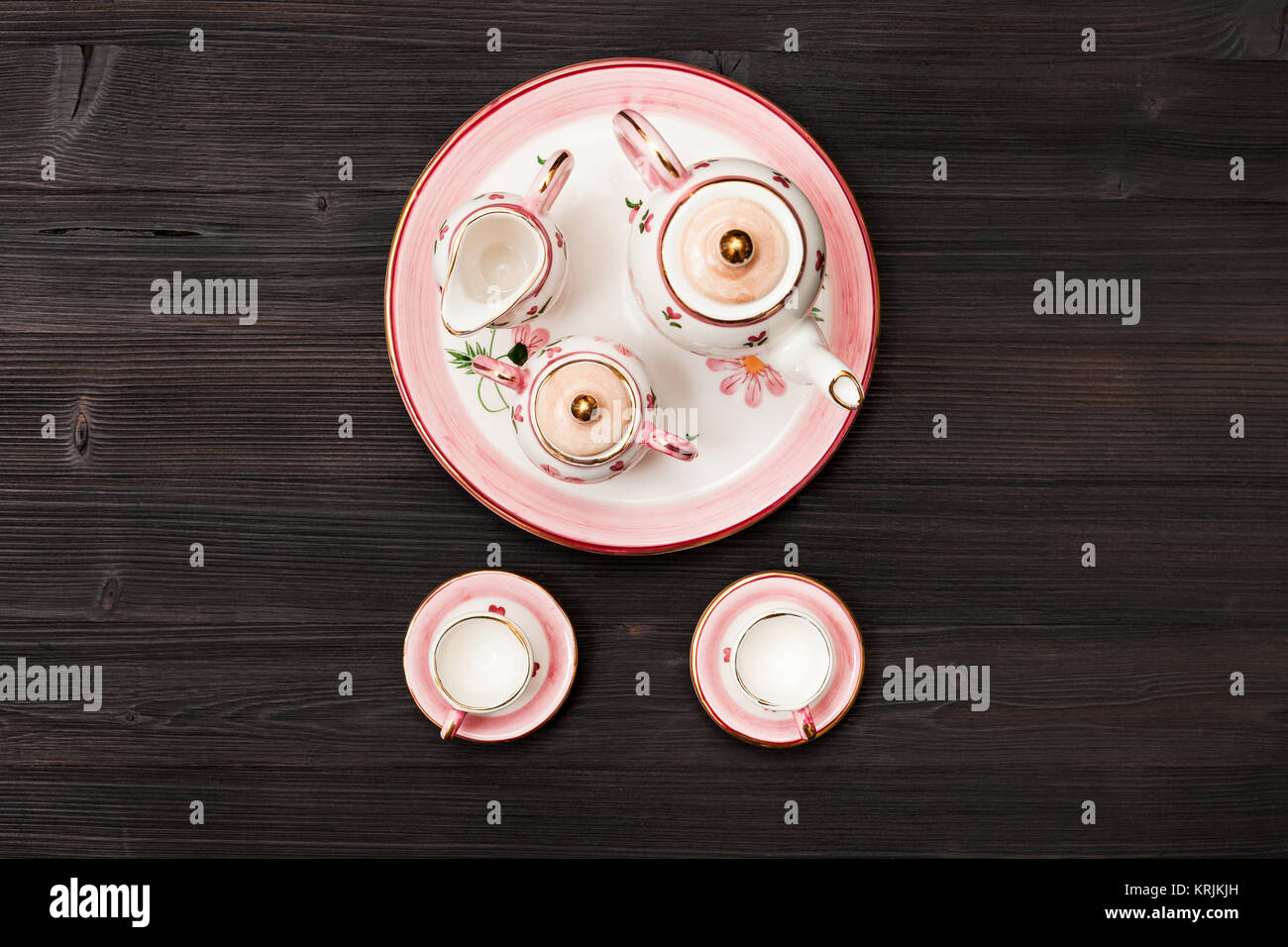 top view of pink tea set on dark brown table Stock Photo - Alamy