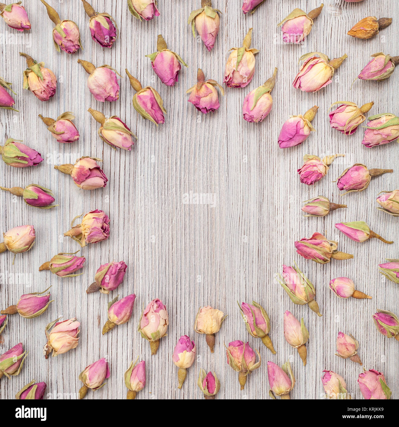 round frame from rose flower buds on wooden plank Stock Photo - Alamy