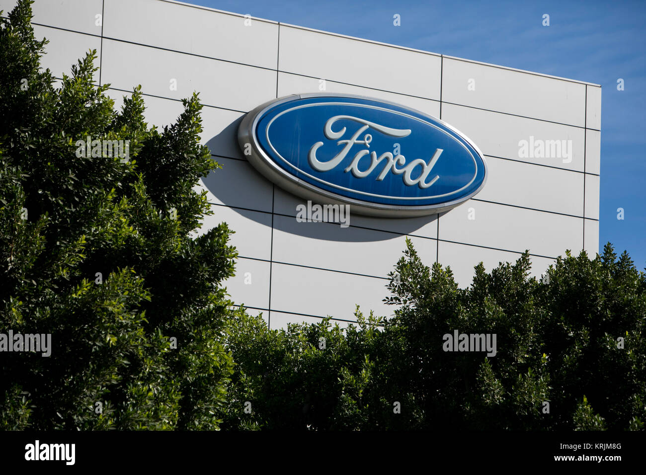 A logo sign outside of a facility occupied by The Ford Motor Company in ...
