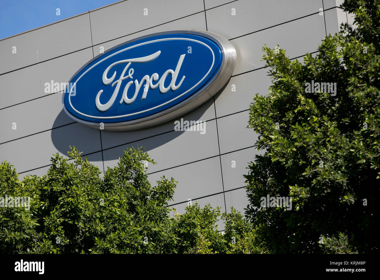 A logo sign outside of a facility occupied by The Ford Motor Company in ...