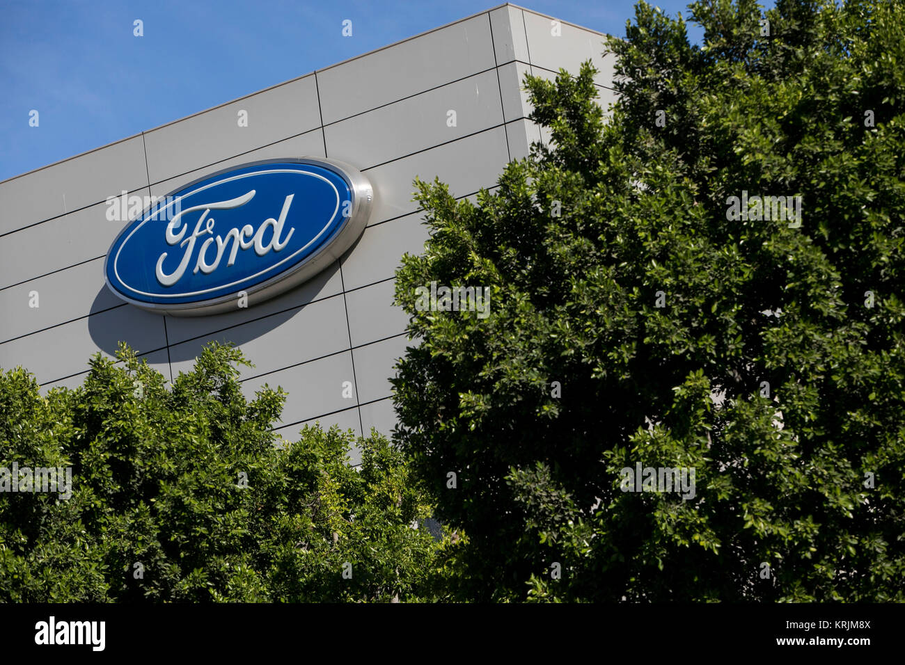 A logo sign outside of a facility occupied by The Ford Motor Company in ...