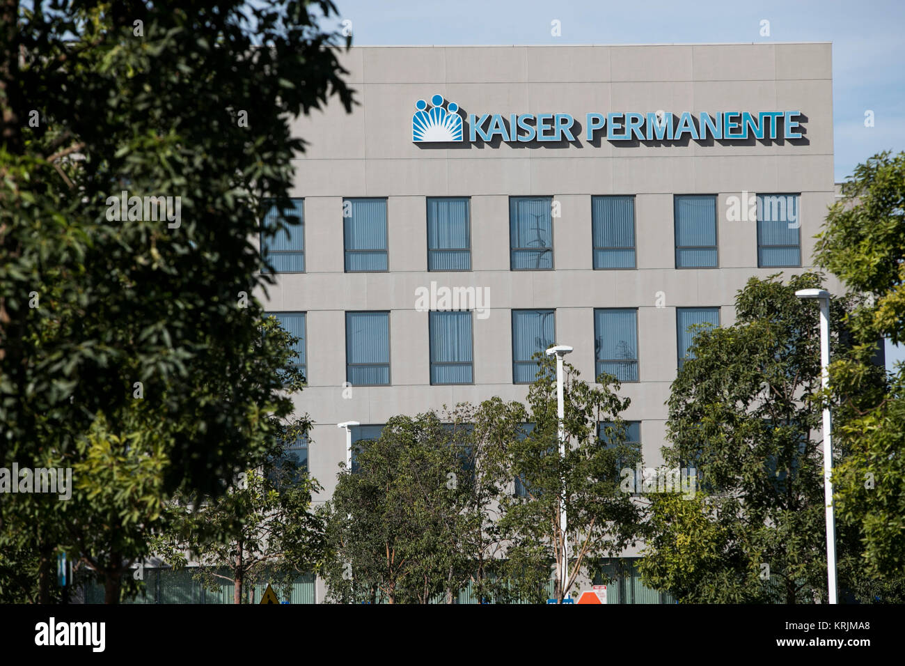 A logo sign outside of a facility occupied by Kaiser Permanente in ...