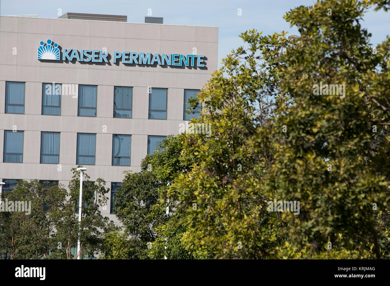 A logo sign outside of a facility occupied by Kaiser Permanente in ...
