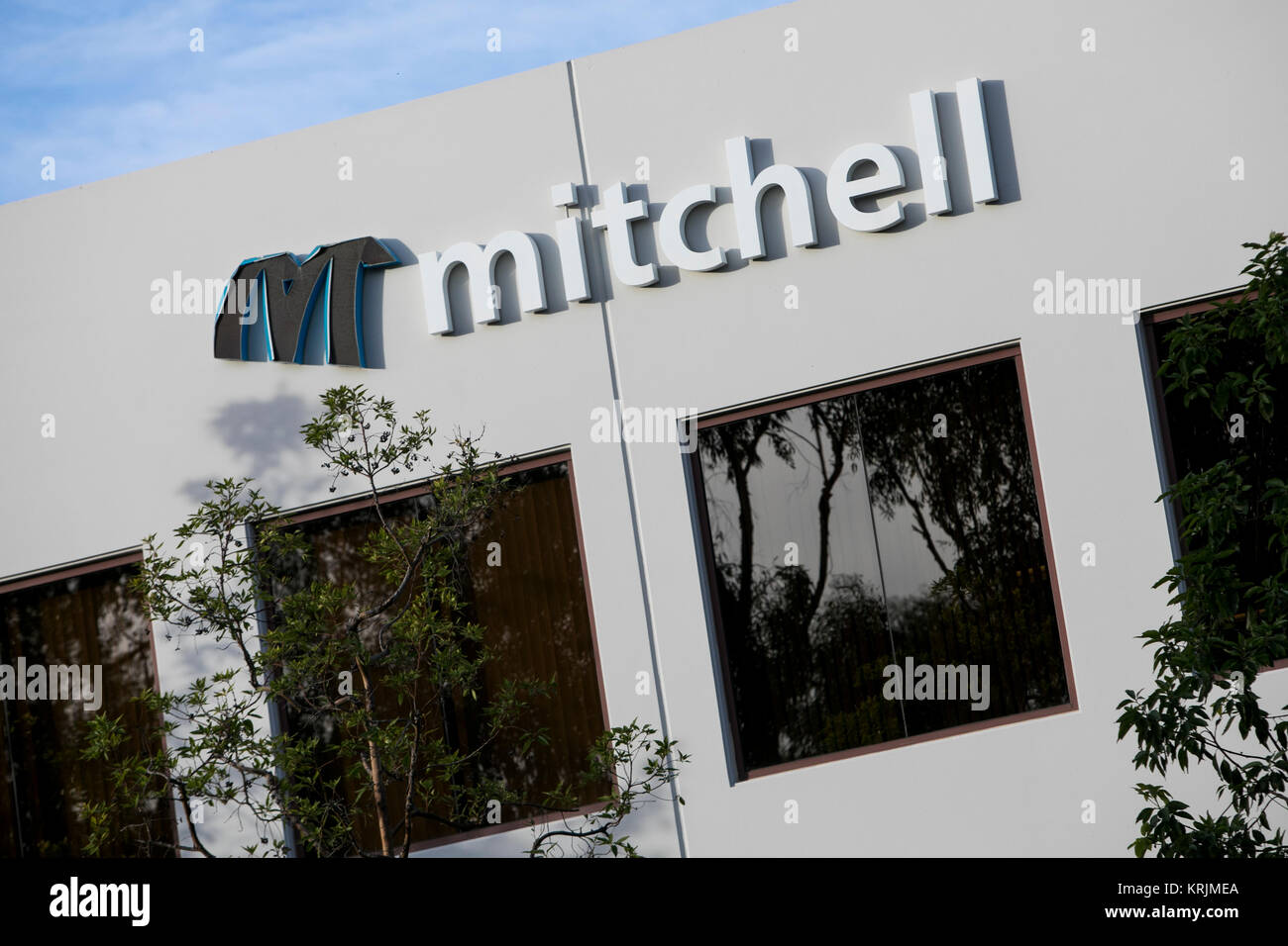 A logo sign outside of a facility occupied by Mitchell International ...