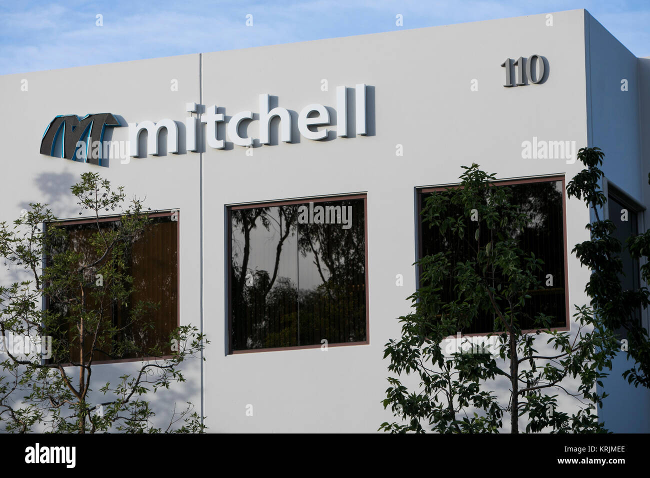 A logo sign outside of a facility occupied by Mitchell International ...