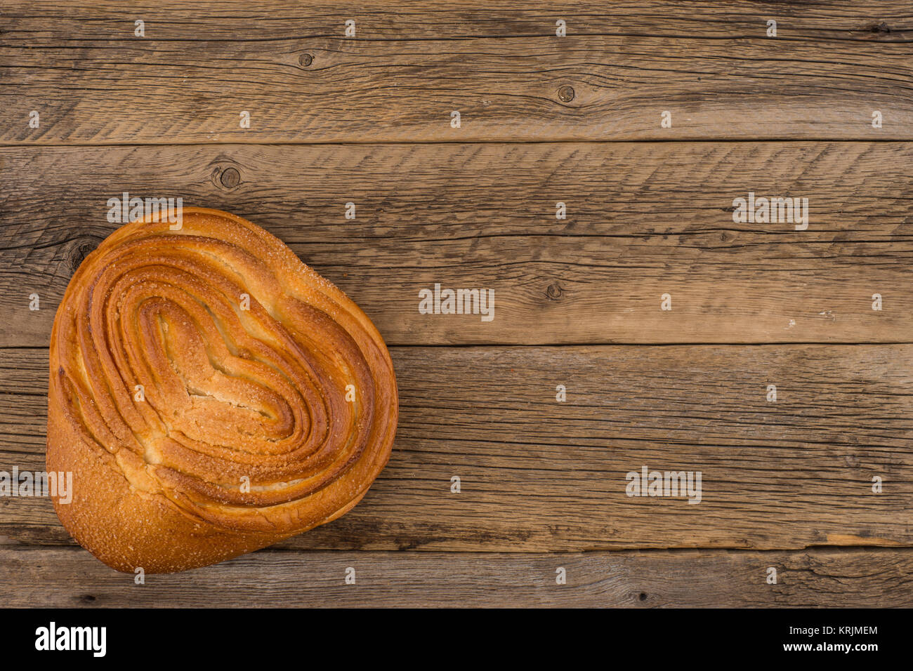 Sweet bun on old wooden table Stock Photo - Alamy
