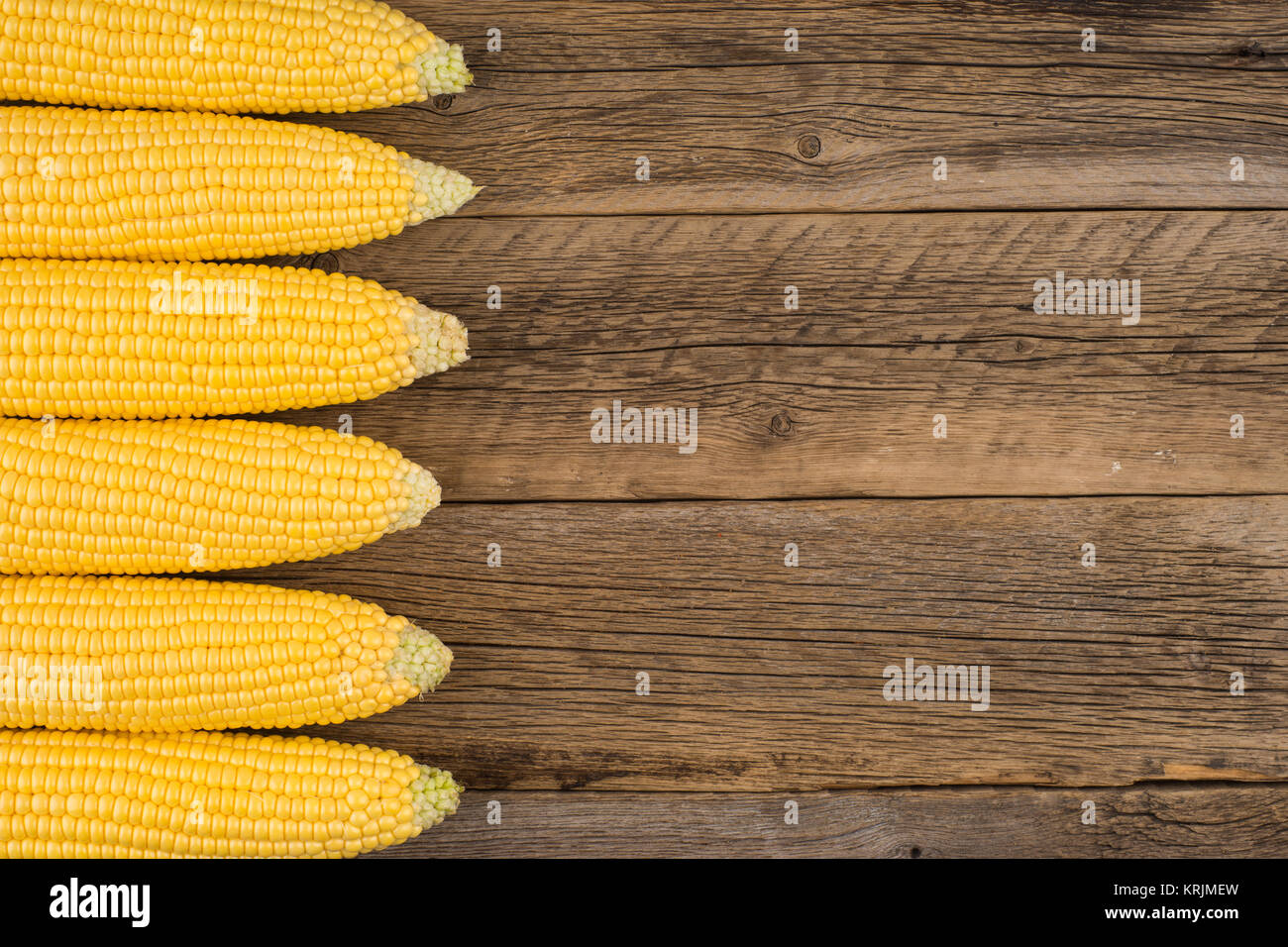 Fresh corn on cobs on rustic wooden table Stock Photo - Alamy
