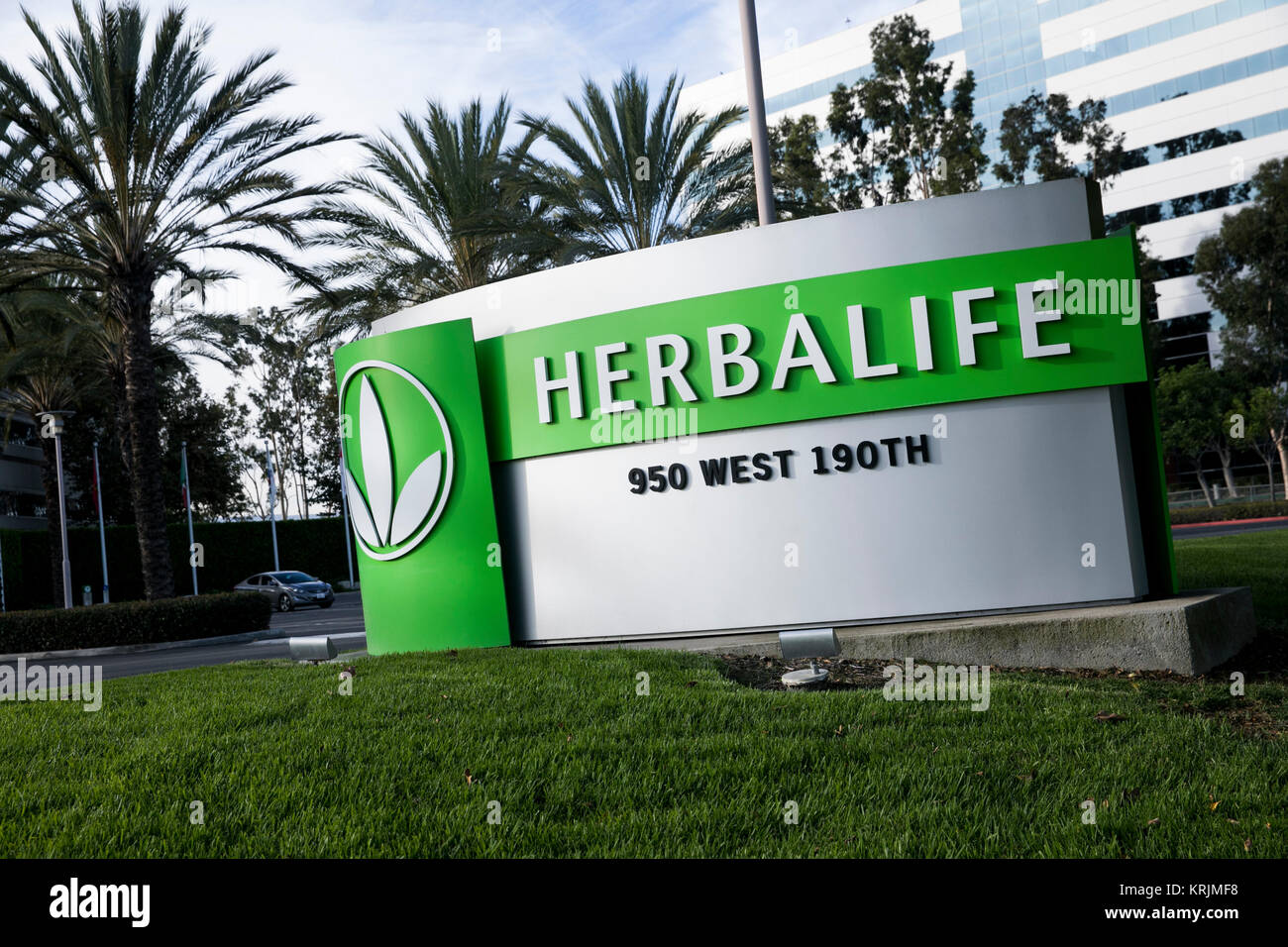 A logo sign outside of a facility occupied by Herbalife International ...
