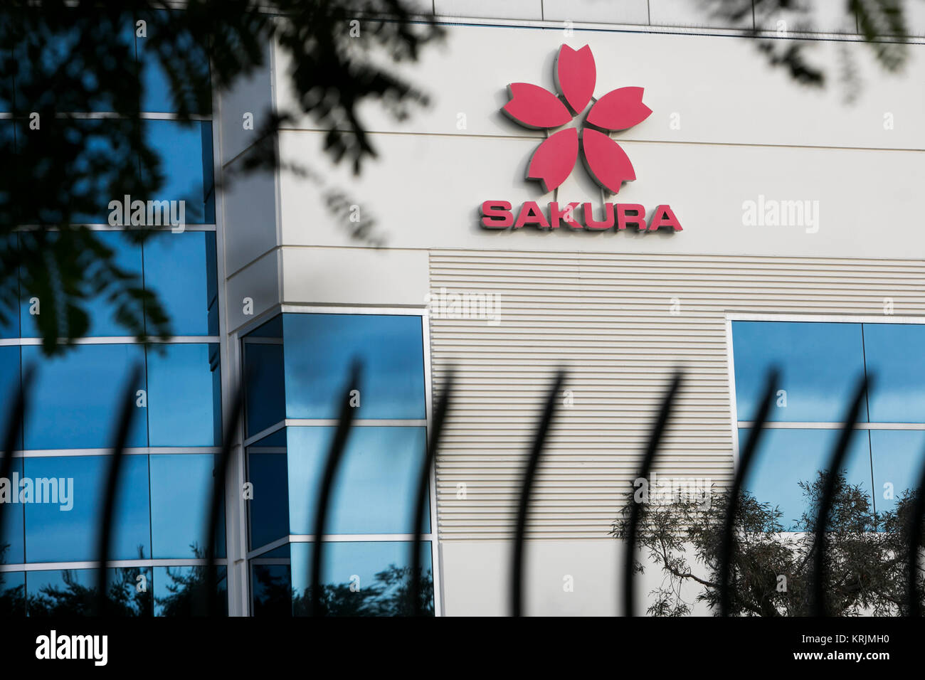 A logo sign outside of a facility occupied by Sakura Finetek in ...
