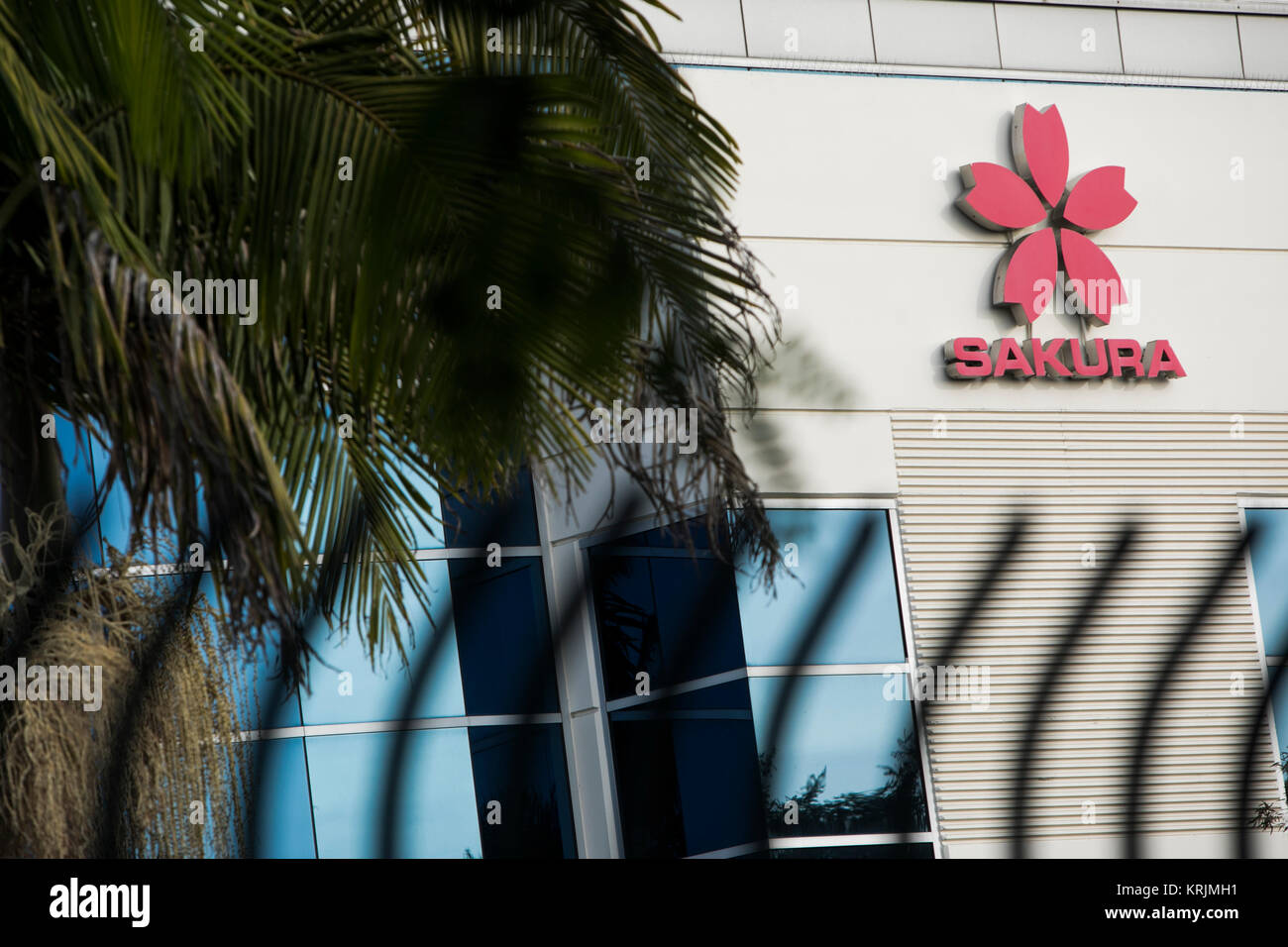 A logo sign outside of a facility occupied by Sakura Finetek in ...