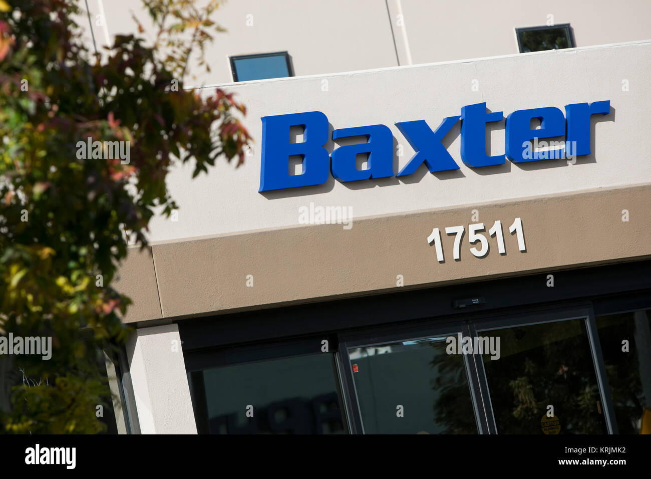 A logo sign outside of a facility occupied by Baxter International Inc ...
