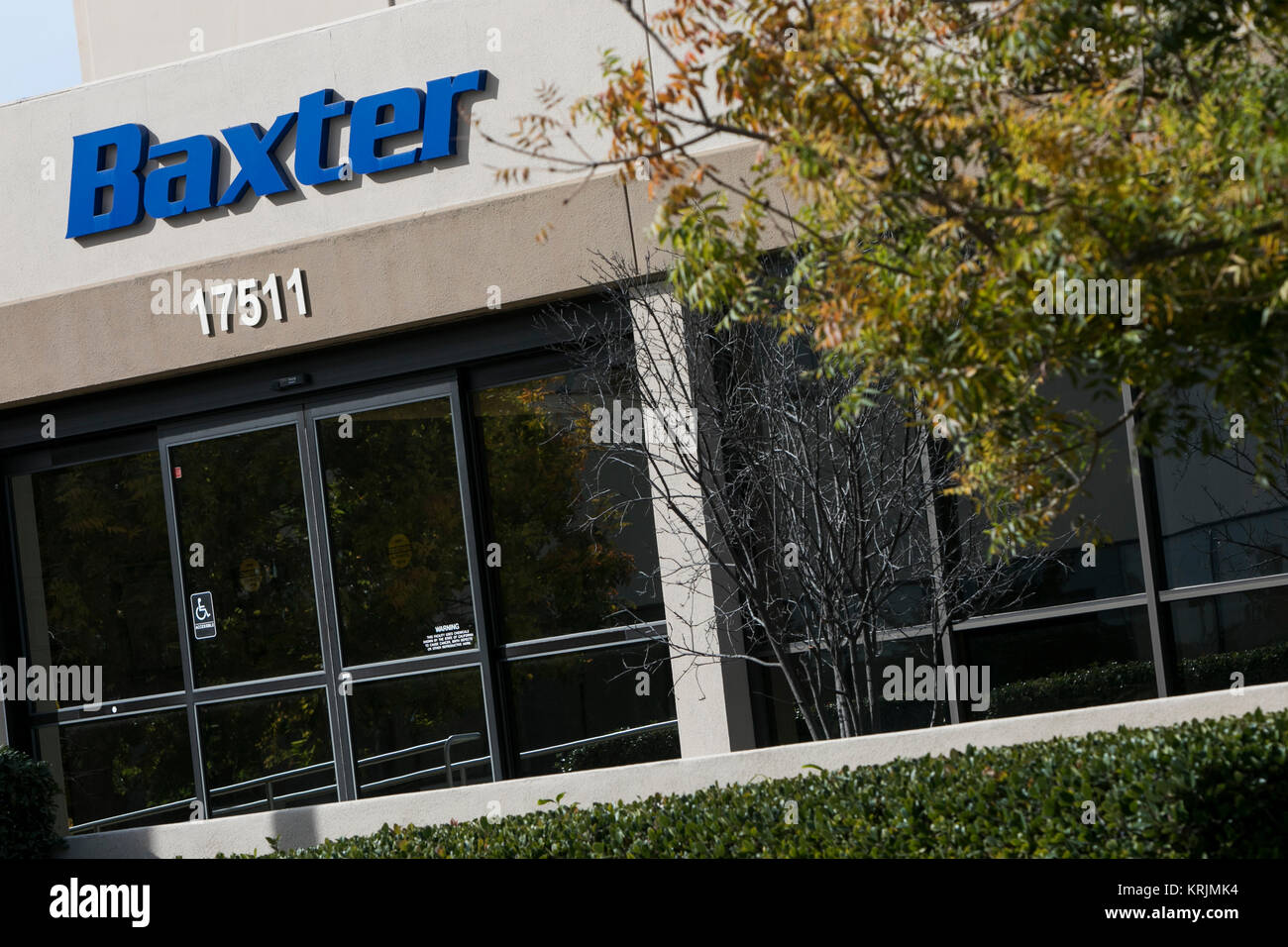 A logo sign outside of a facility occupied by Baxter International Inc ...