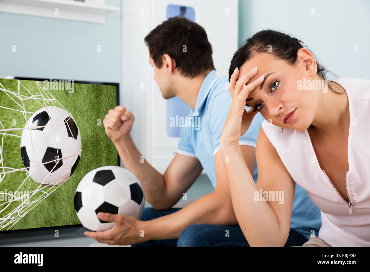 Man Busy Watching Sport On Television Ignoring His Wife Stock Photo - Alamy