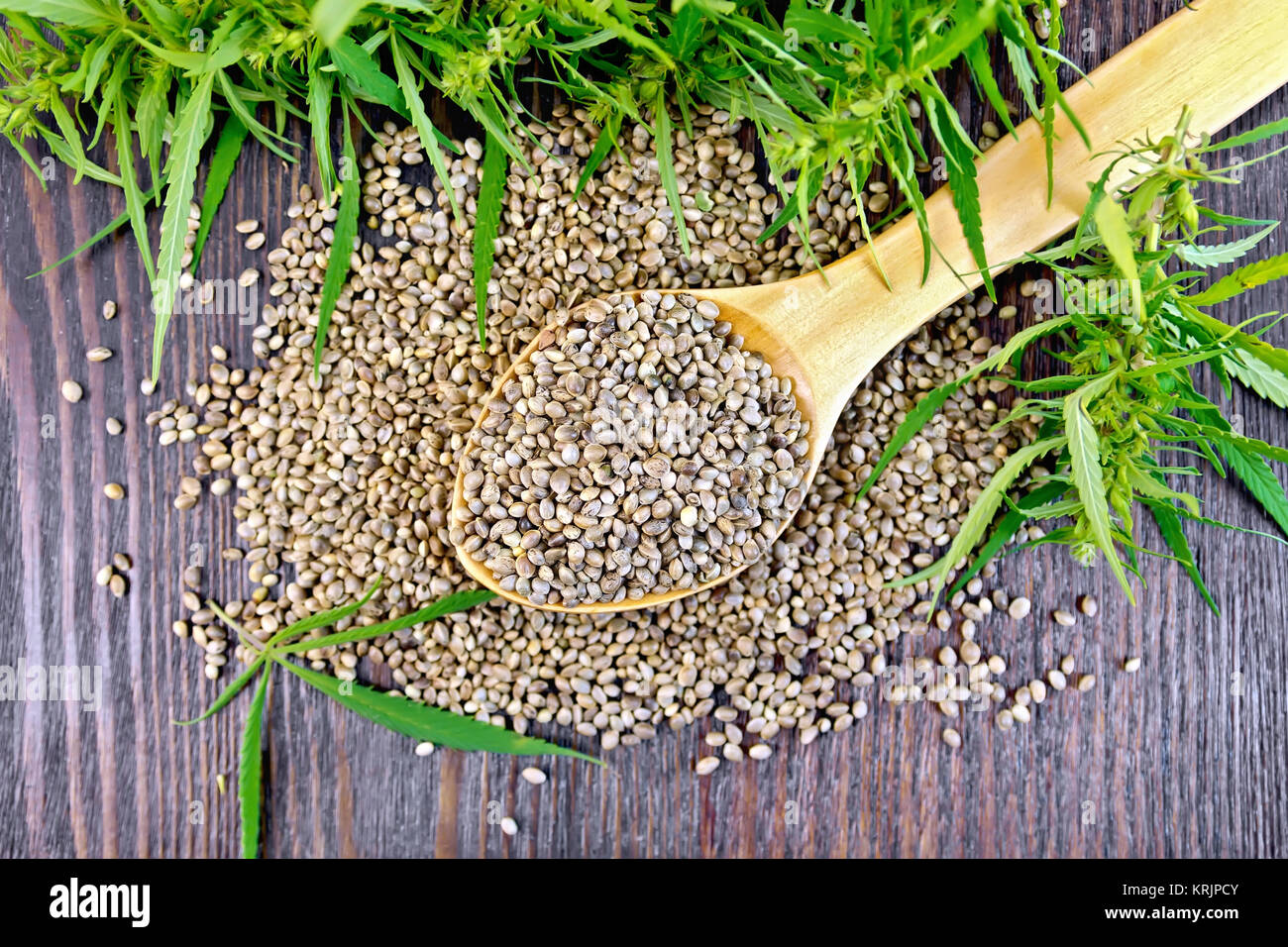 Grain hemp in spoon on dark board top Stock Photo - Alamy