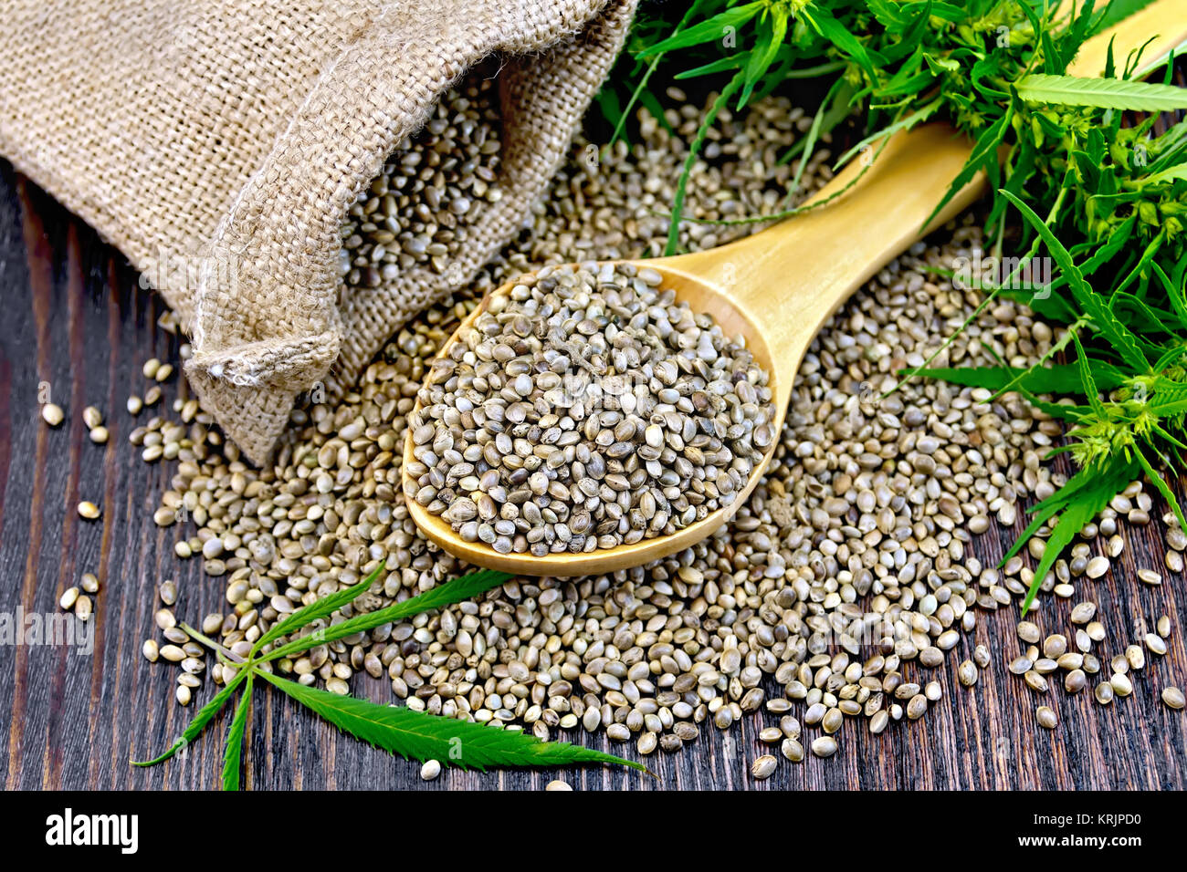 Grain hemp in spoon with bag on board Stock Photo - Alamy