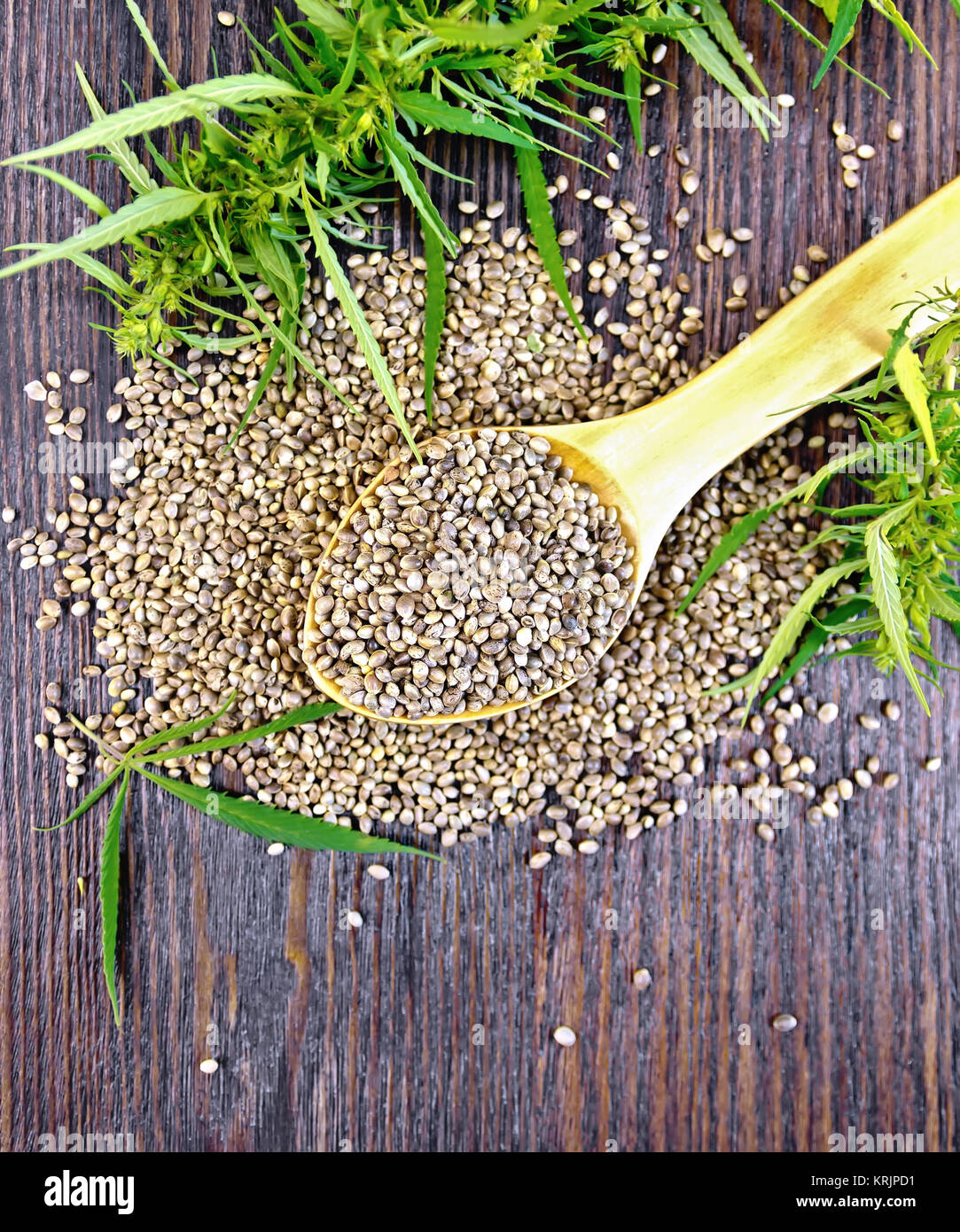 Grain hemp in spoon with leaf on board top Stock Photo - Alamy
