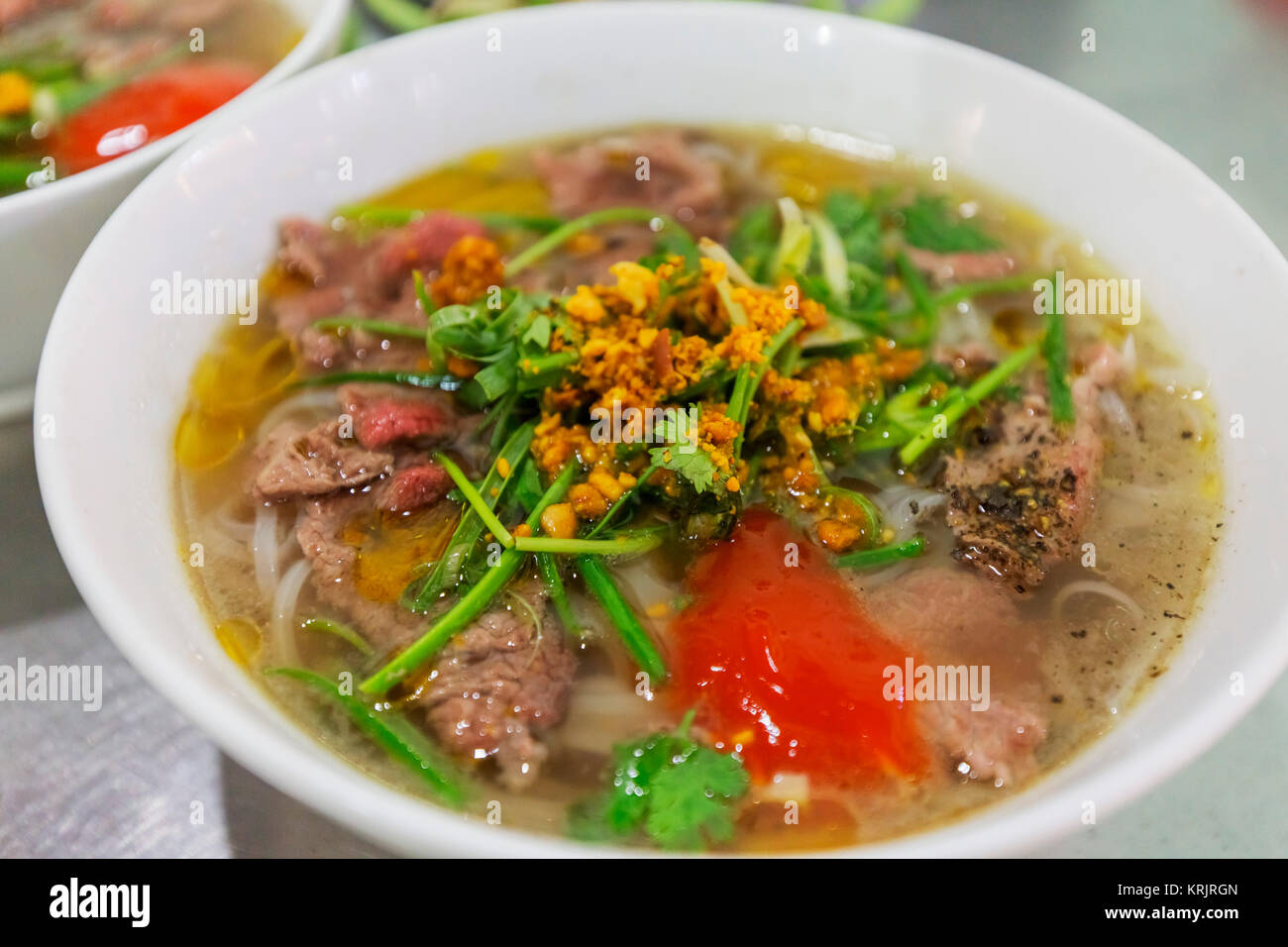 Vietnanese beef pho with sriracha sauce shot from overhead at Hoi An ...