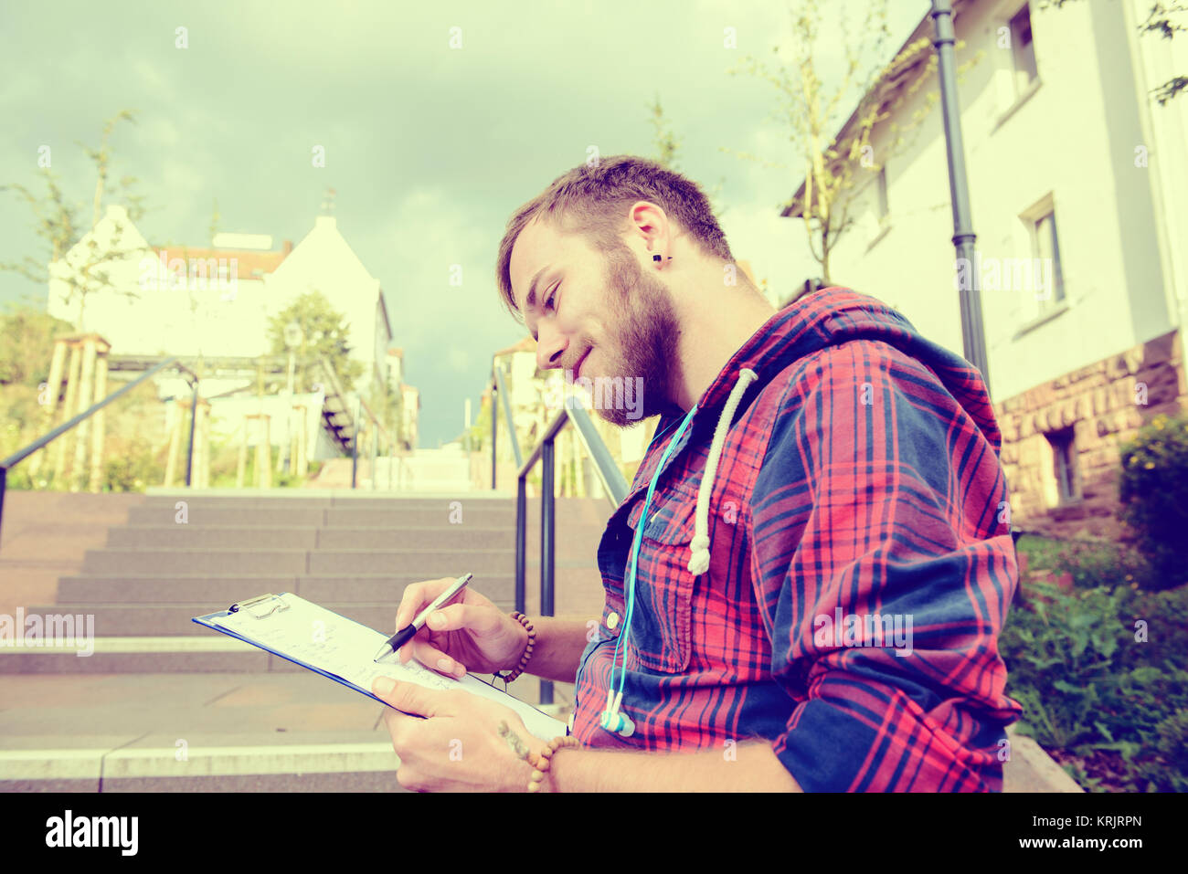 young man is reading a book Stock Photo - Alamy