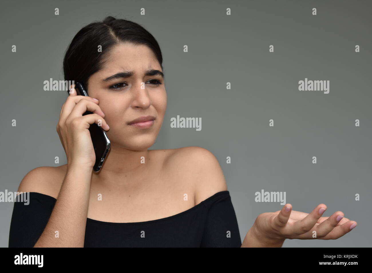 Female Using Cell Phone And Unhappy Stock Photo - Alamy