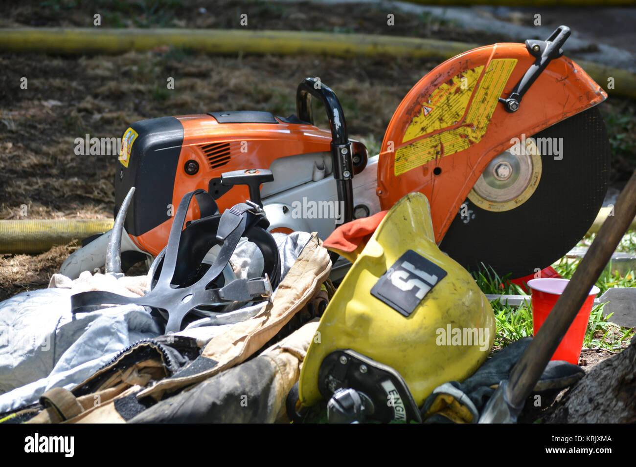 Fire department saw and helmet at a house fire Stock Photo - Alamy