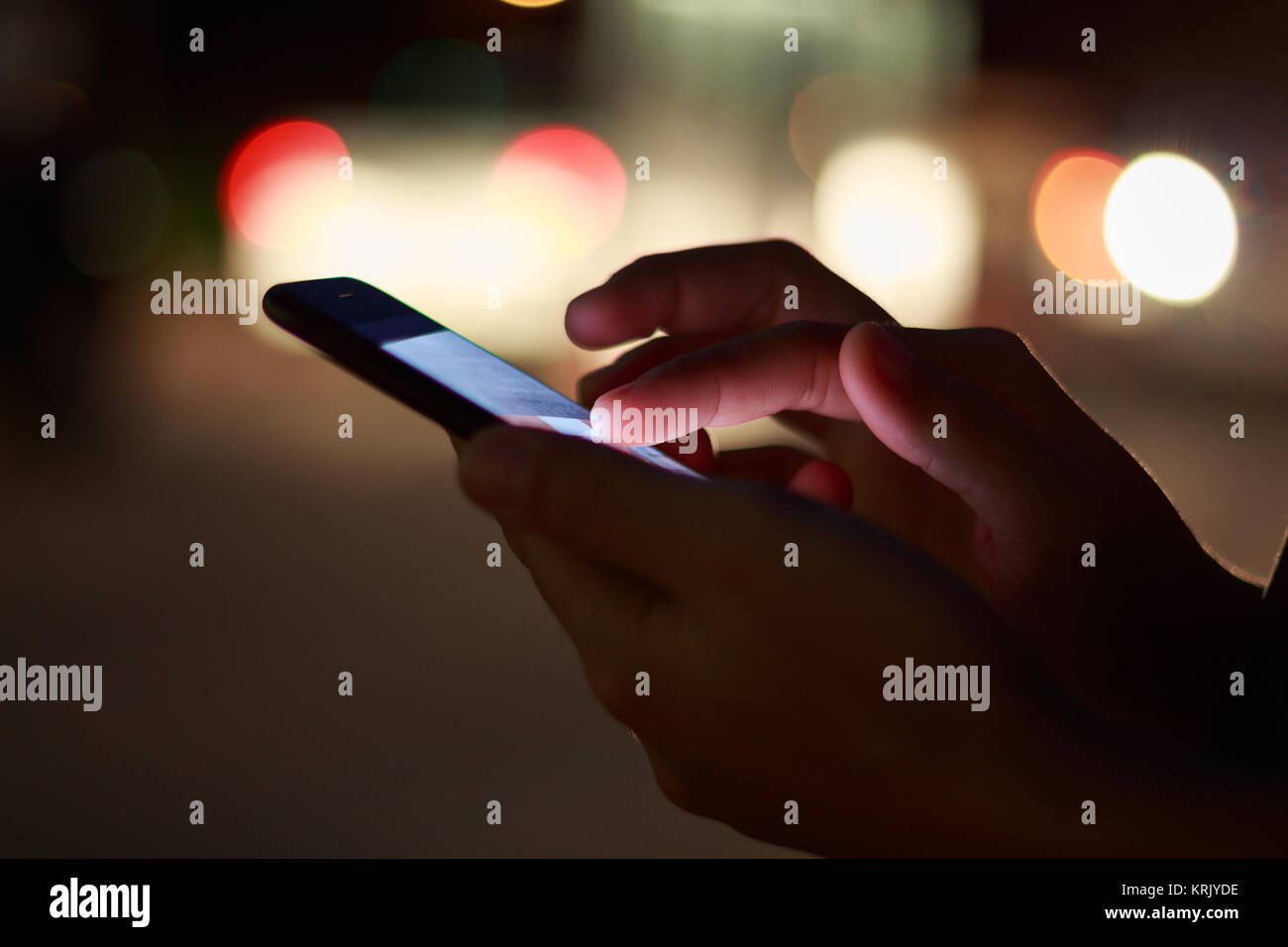 close-up hand using phone in night time on street Stock Photo - Alamy