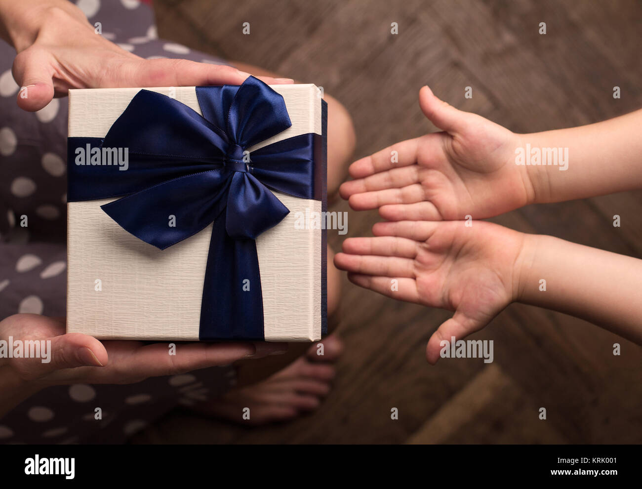 Mother giving a big gift boxes to her kid with open hand Stock Photo ...