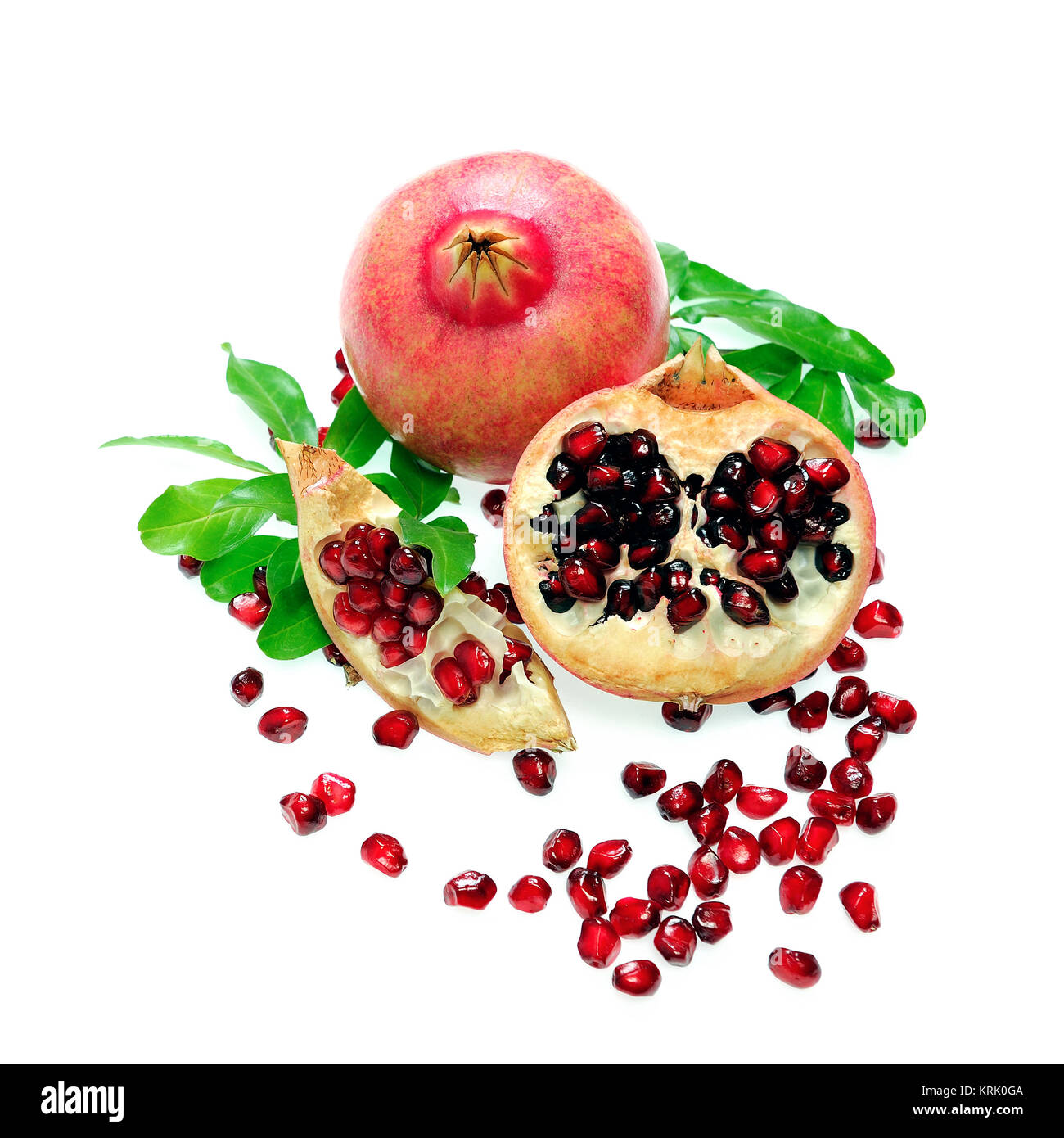 Close up of a ripe pomegranate fruit and seeds on white background ...