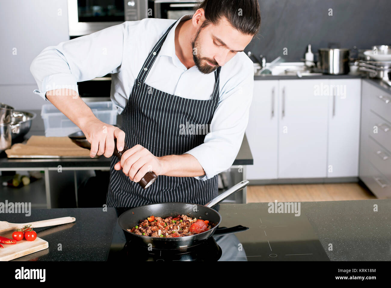 Chef cooking dishes in a frying pan Stock Photo - Alamy