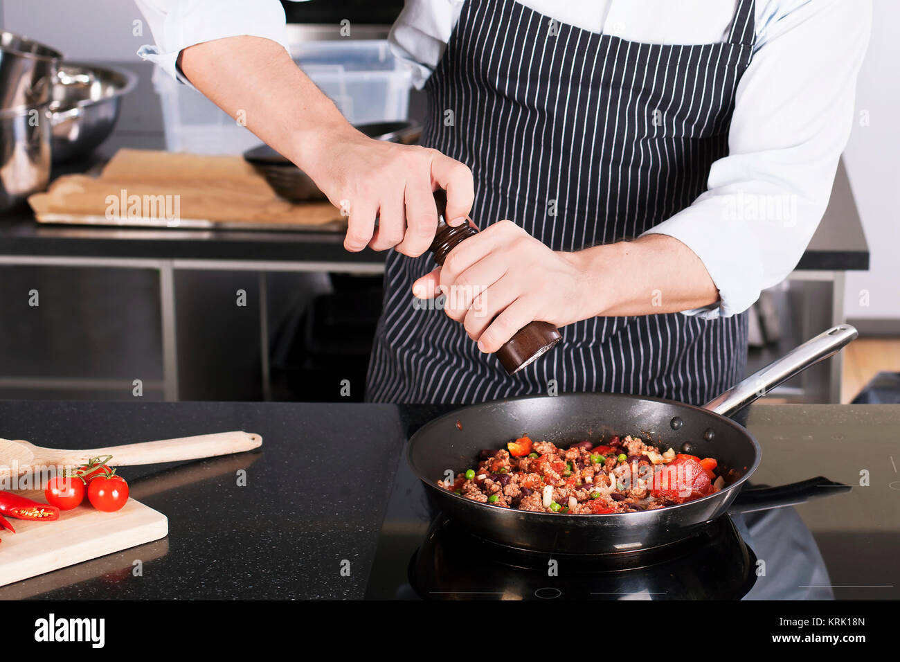 Chef preparing dishes in a frying pan Stock Photo - Alamy