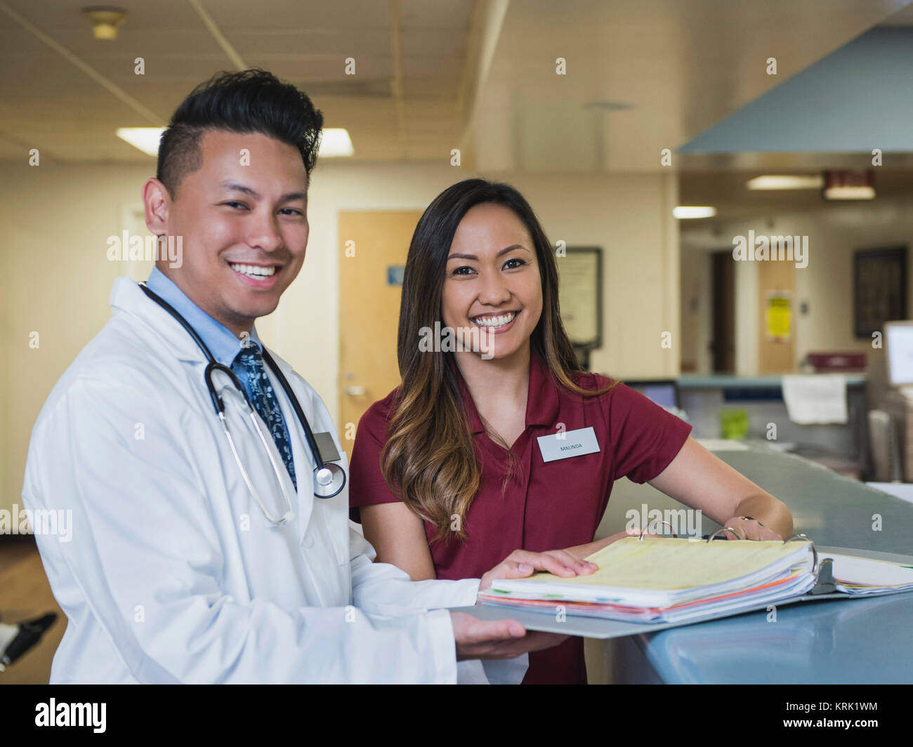 Portrait of smiling doctor and nurse with binder in hospital Stock ...