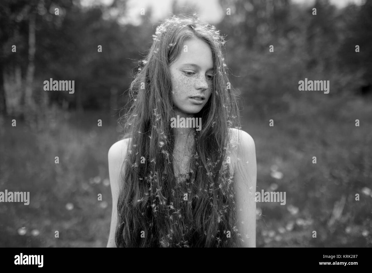Caucasian girl standing in field with fuzz in hair Stock Photo - Alamy