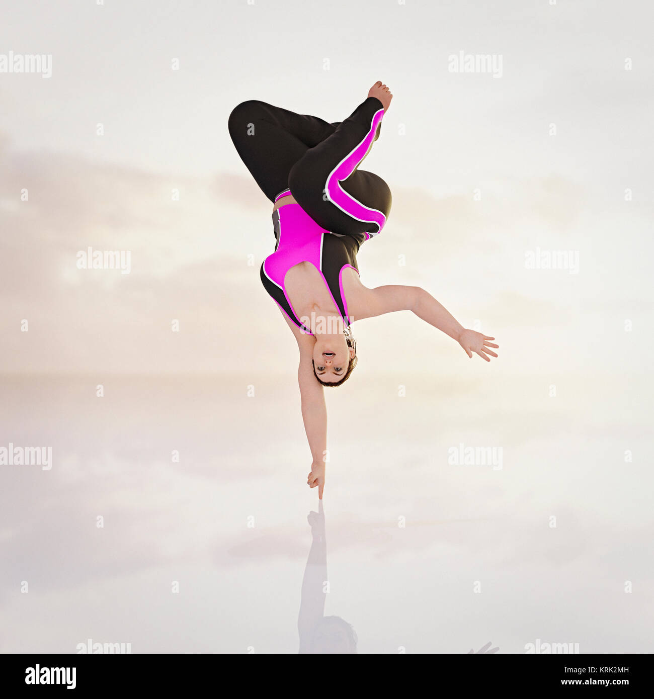 Woman balancing upside-down on fingertip Stock Photo - Alamy