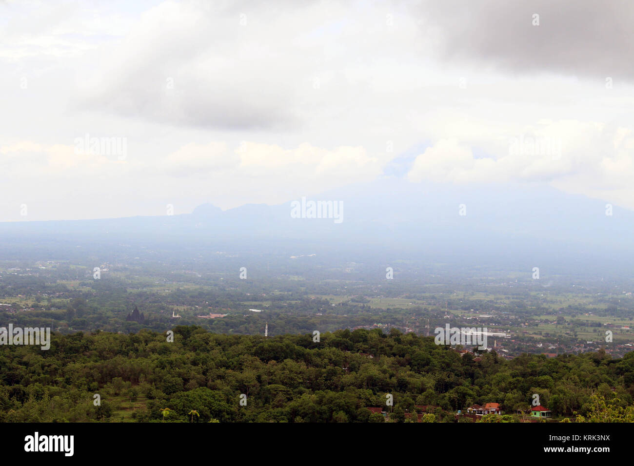 The view of Prambanan as seen from top and far-away. A volcano as the ...