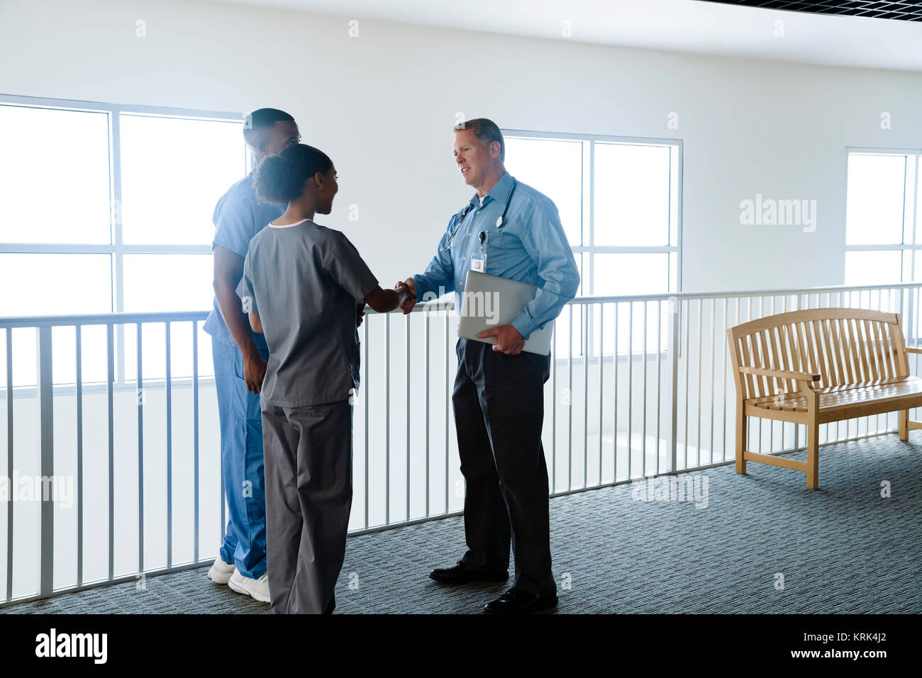 Doctor and nurse shaking hands Stock Photo - Alamy