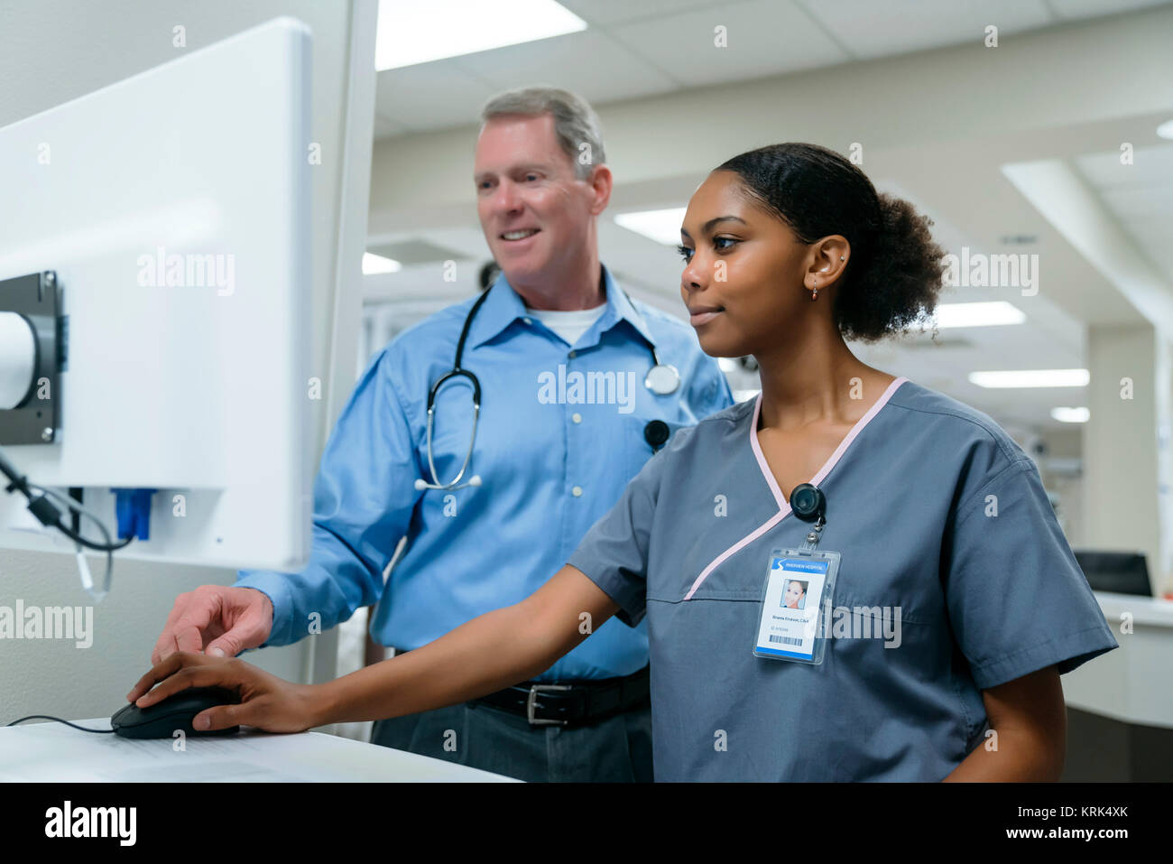 Doctor and nurse using computer Stock Photo - Alamy