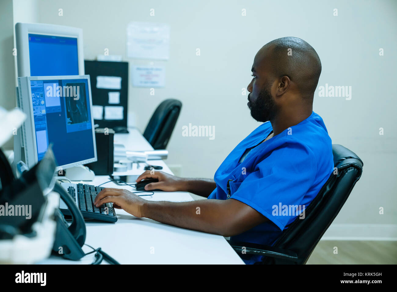 Black nurse using computer Stock Photo - Alamy