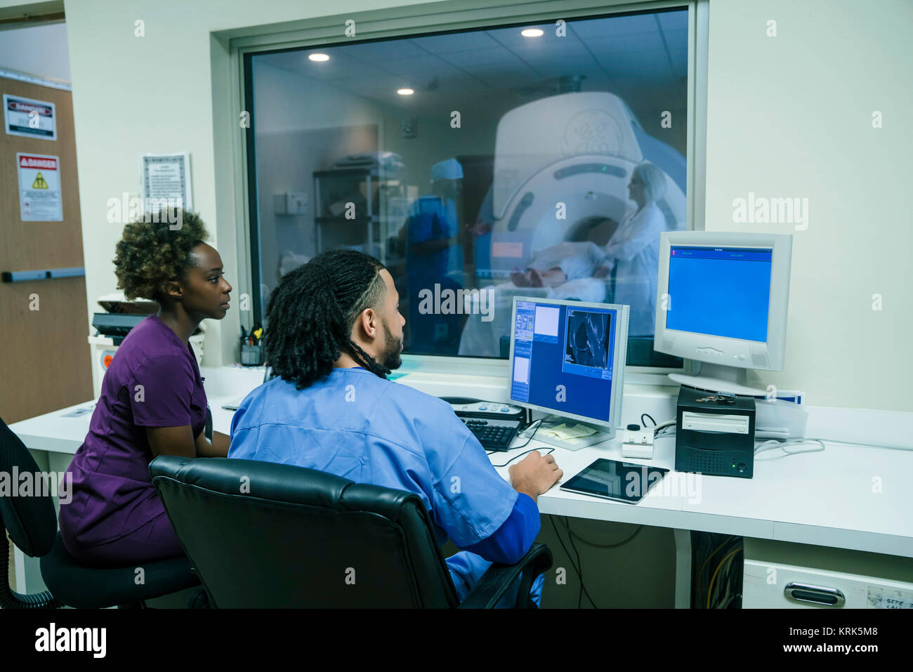 Nurses using computer near scanner Stock Photo - Alamy