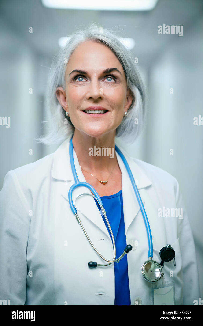 Smiling Caucasian doctor looking up Stock Photo - Alamy